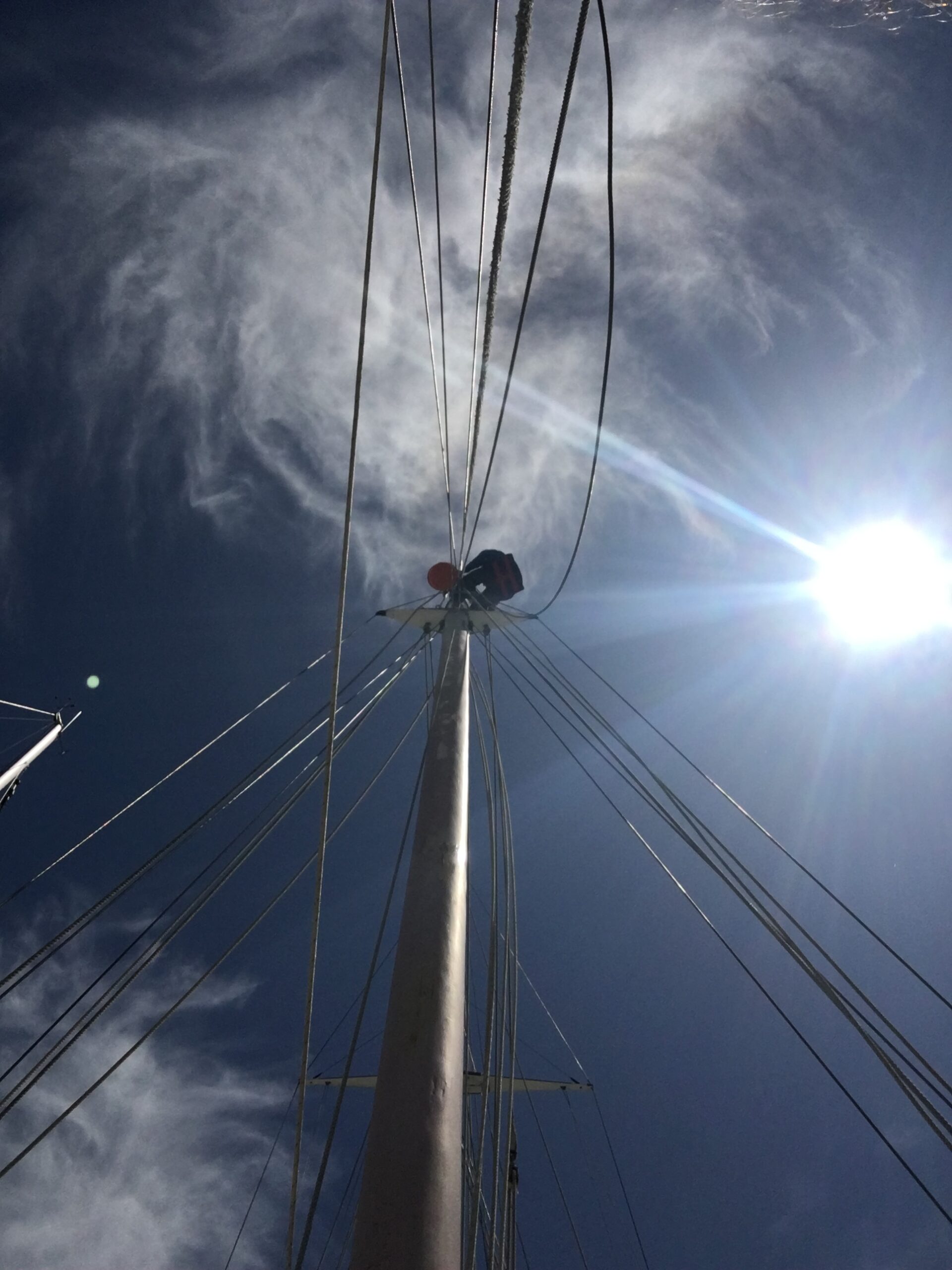 Painting the Masts from the Bosun's Chair - Sailing Mahdee
